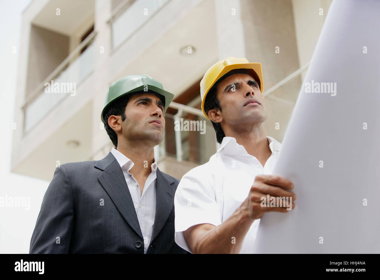 contractors or architects with blueprints Stock Photo - Alamy