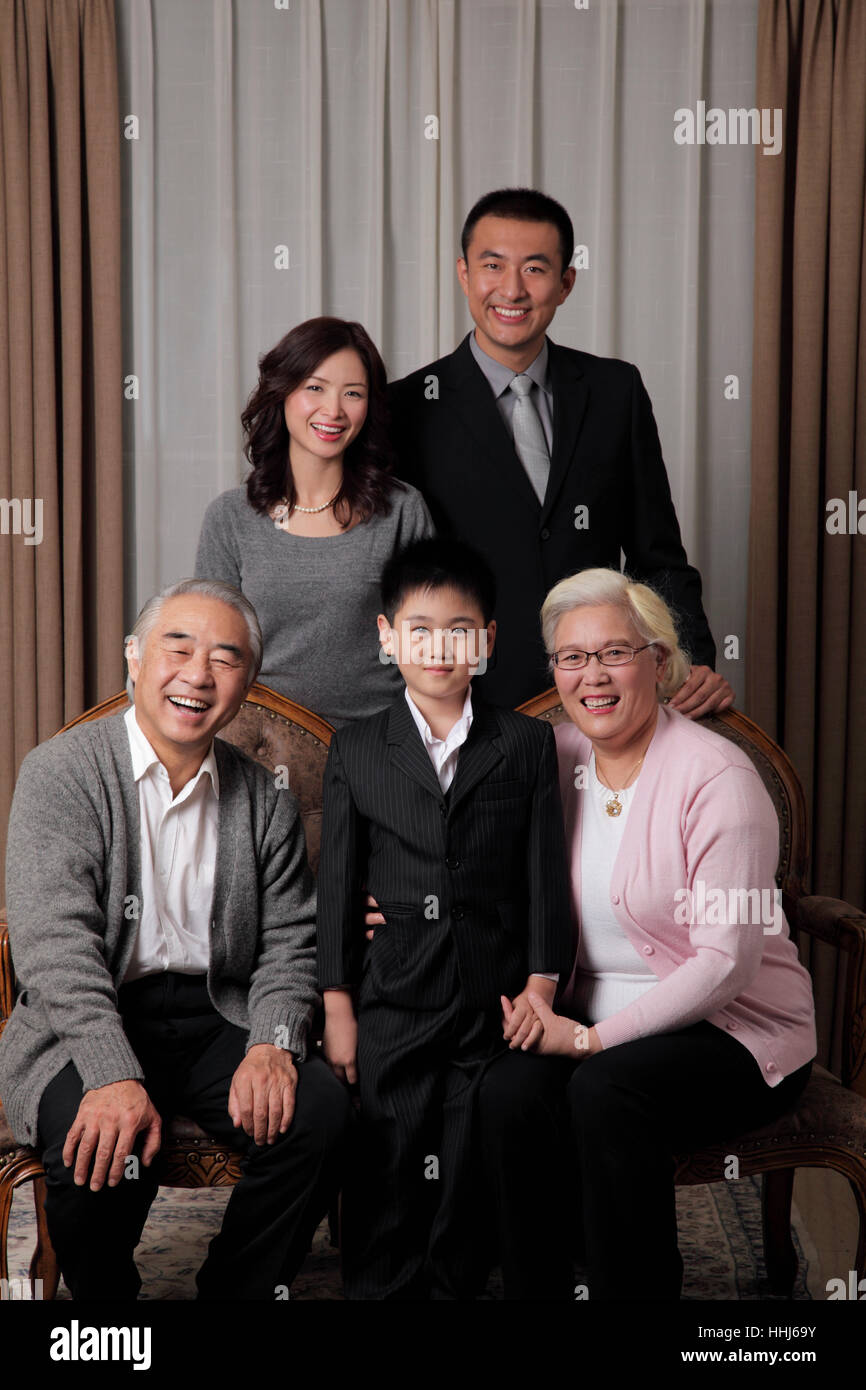 Three generational family posing for a photo together Stock Photo - Alamy