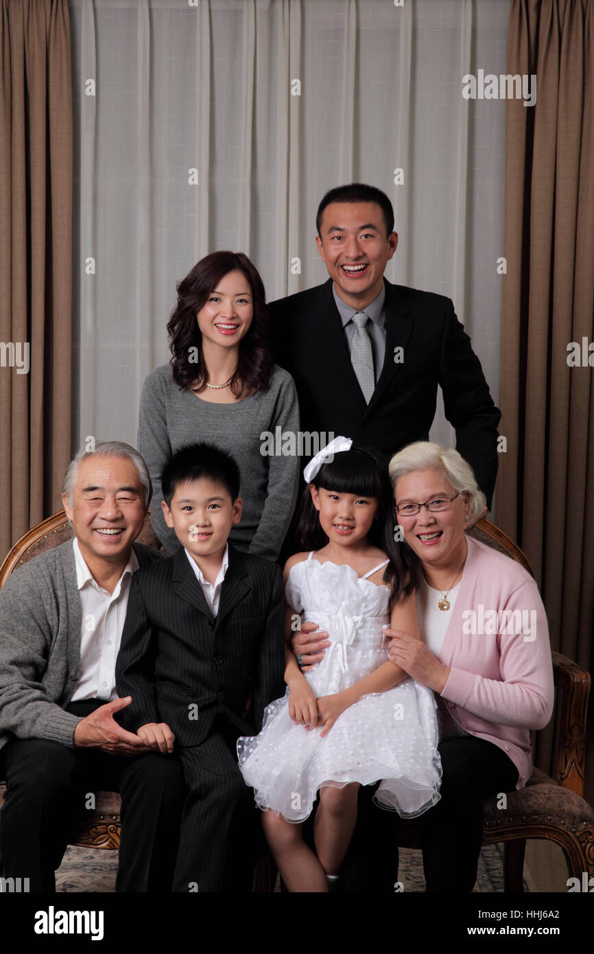 Three generation family posing for a photo together Stock Photo - Alamy