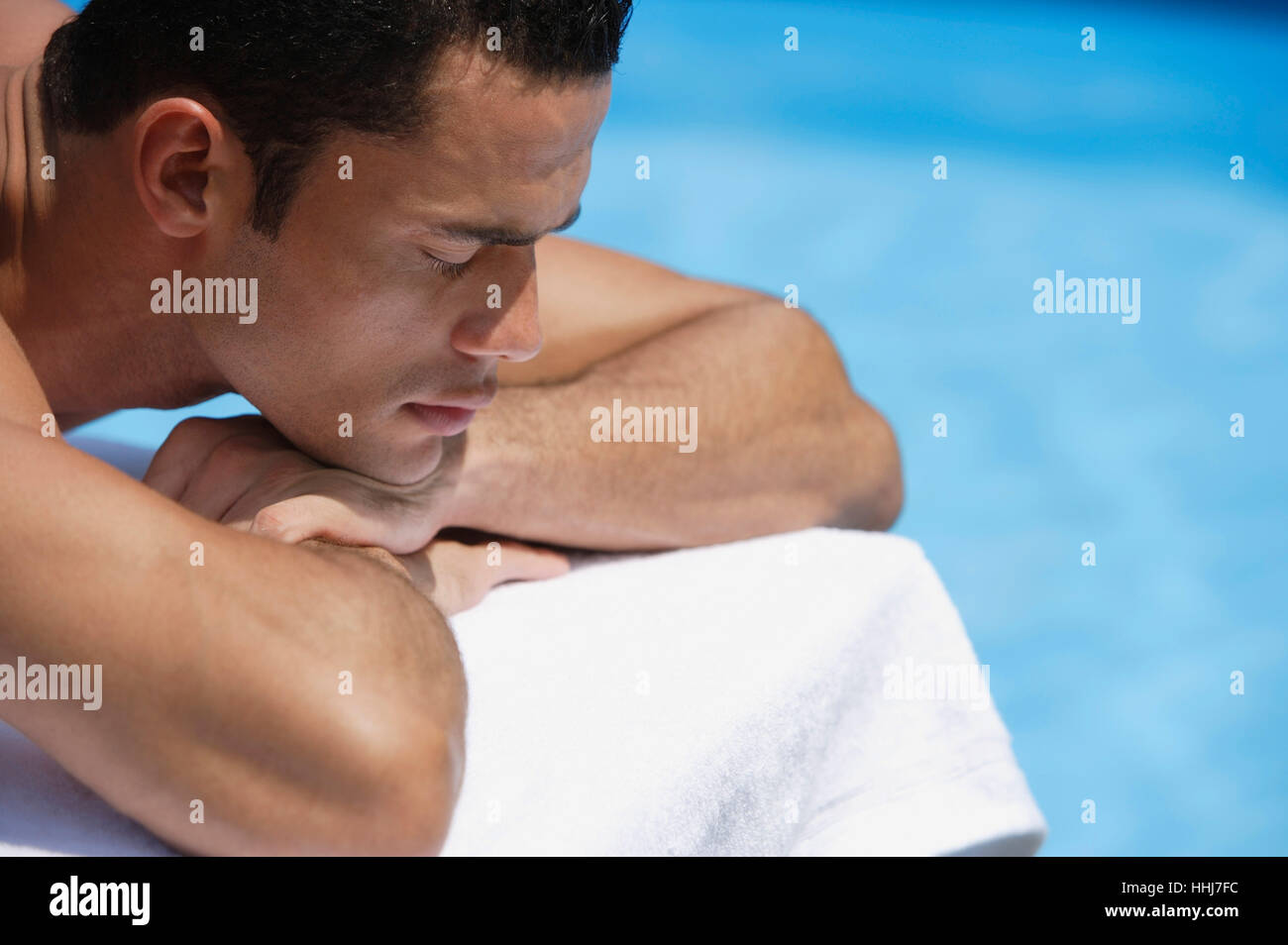 man lying by pool Stock Photo - Alamy