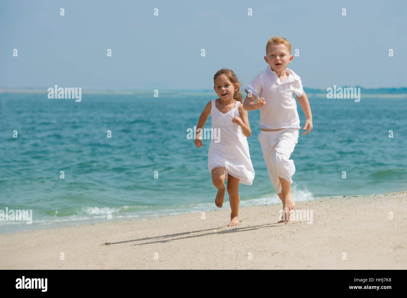 two kids running on beach Stock Photo - Alamy