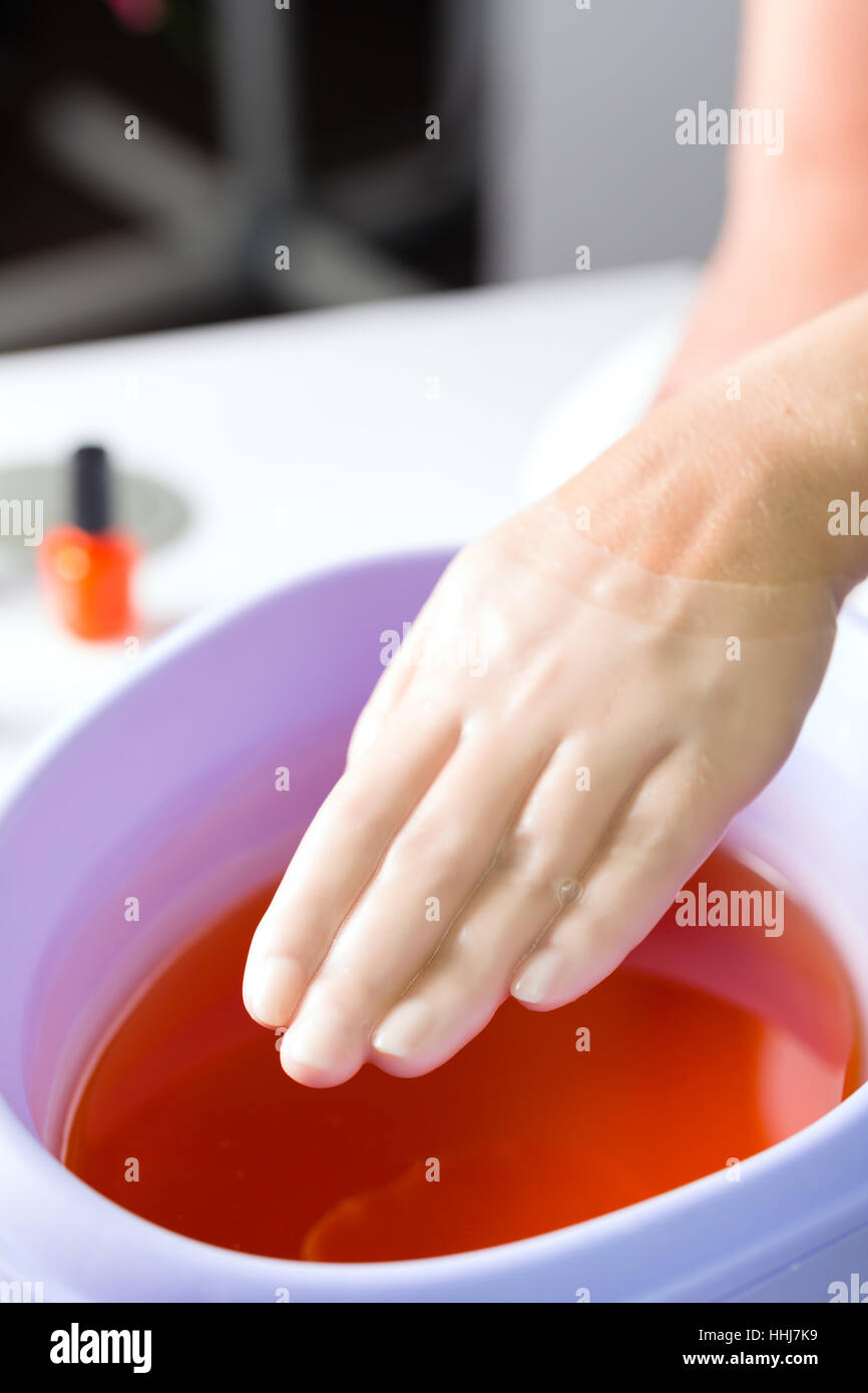 woman in nail salon getting a manicure,she takes a hand bath Stock ...
