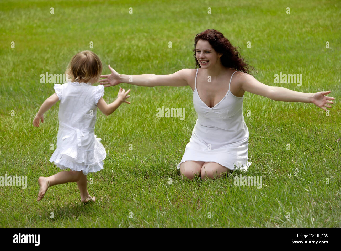Little girl running towards mother Stock Photo - Alamy