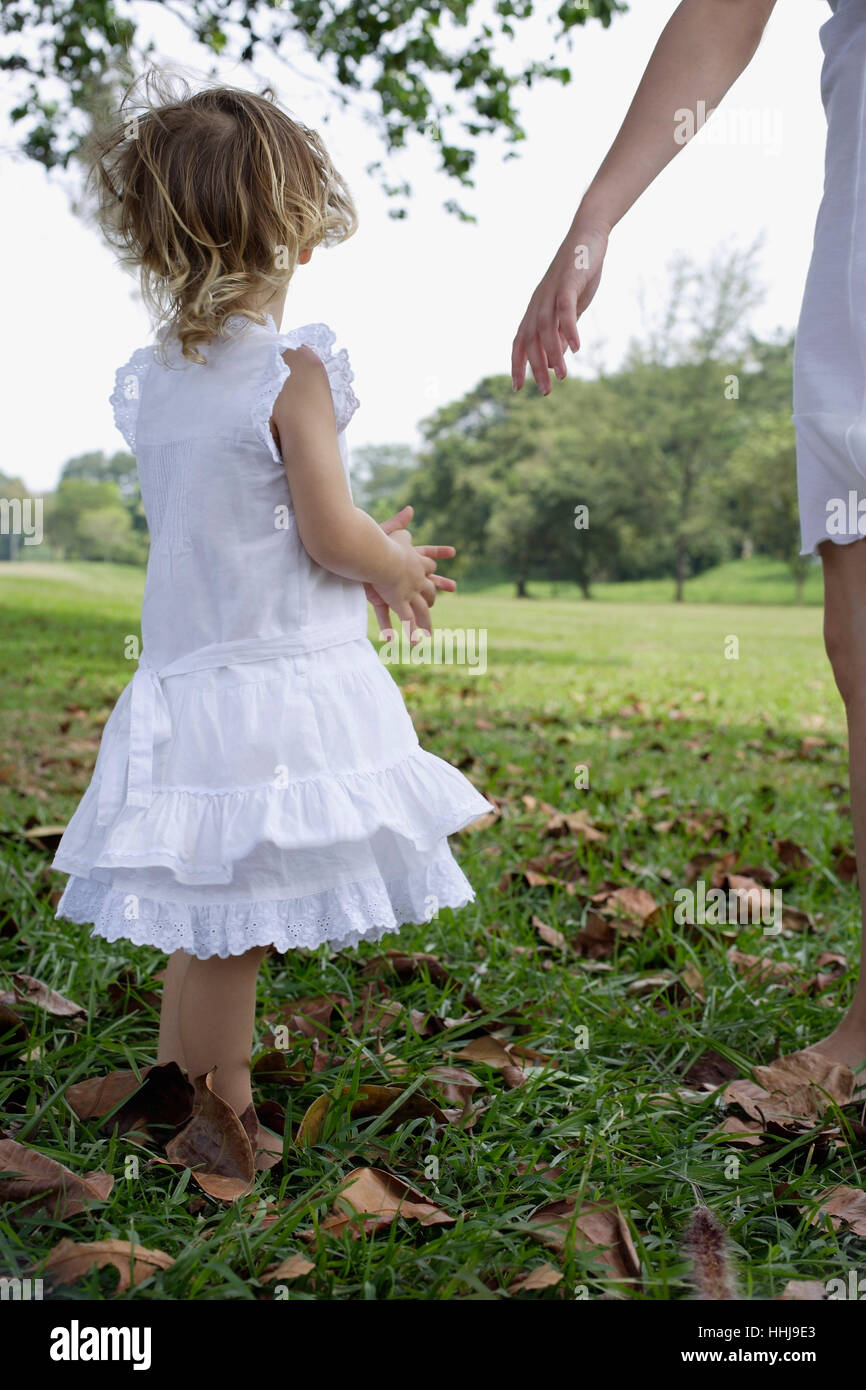 Mom reaching out to hold child's hand Stock Photo - Alamy
