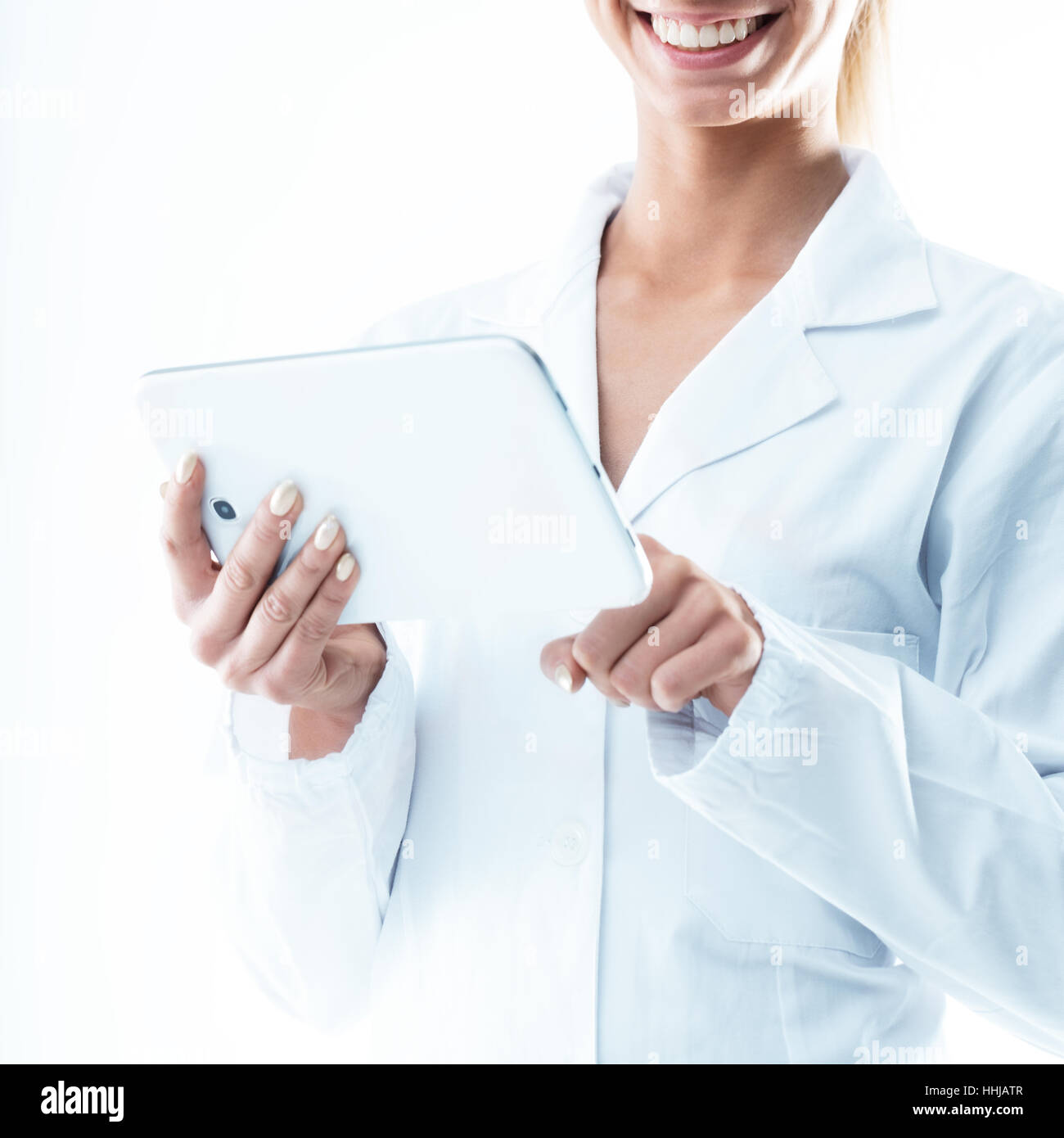 smiling doctor holding a digital tablet and tapping with her index ...
