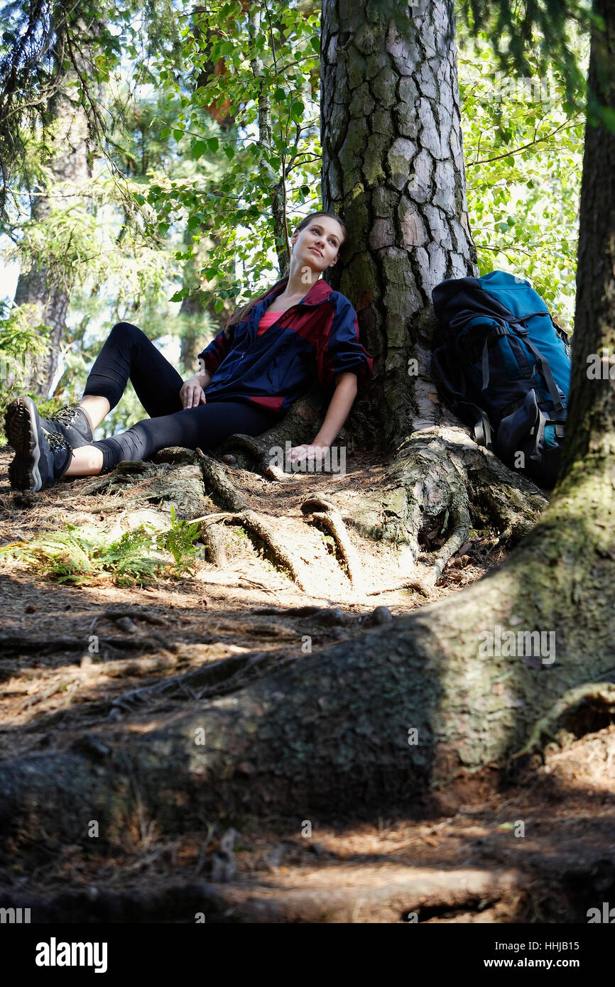 Young woman resting under tree Stock Photo - Alamy