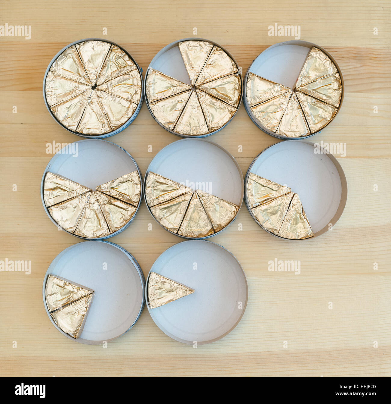 triangles of processed cheese on a wooden table in a variety of forms ...