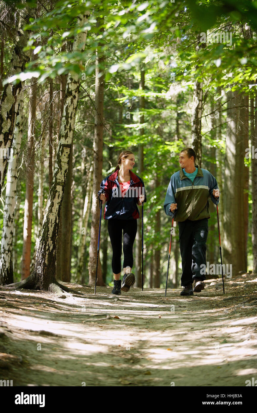 Young couple walking in forest Stock Photo - Alamy