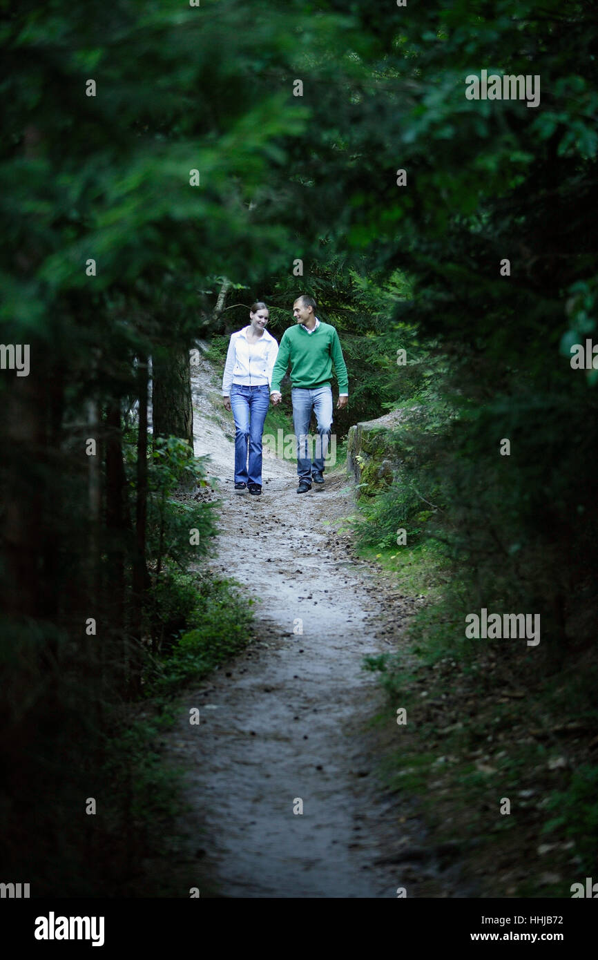 Young couple walking on forest path Stock Photo - Alamy
