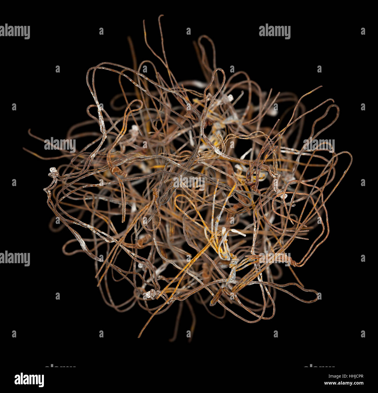 Ball of tangled rusty wire on a black background Stock Photo - Alamy