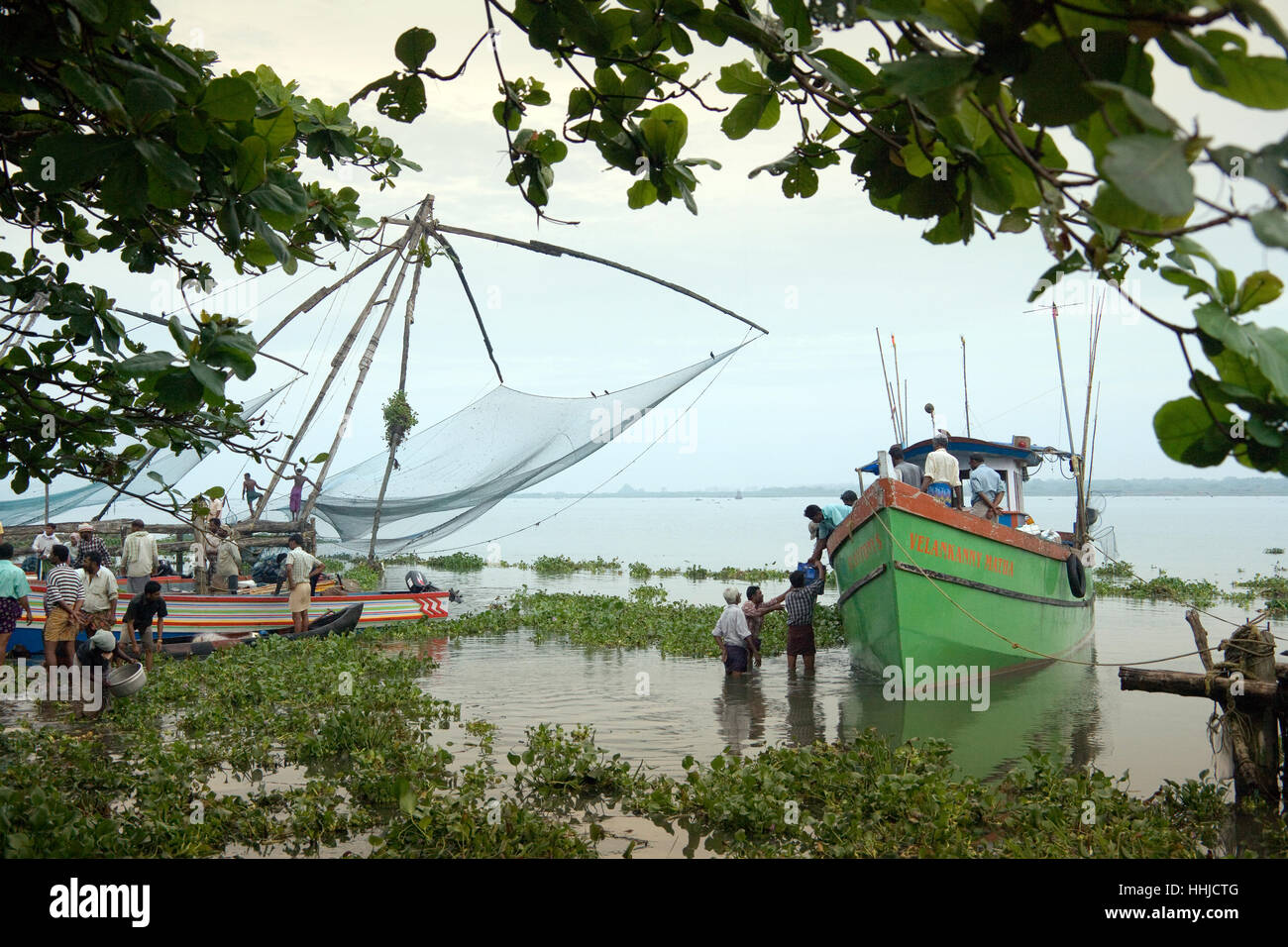 Chinese Fishing Nets and fishing boats landing the nights catch in the ...
