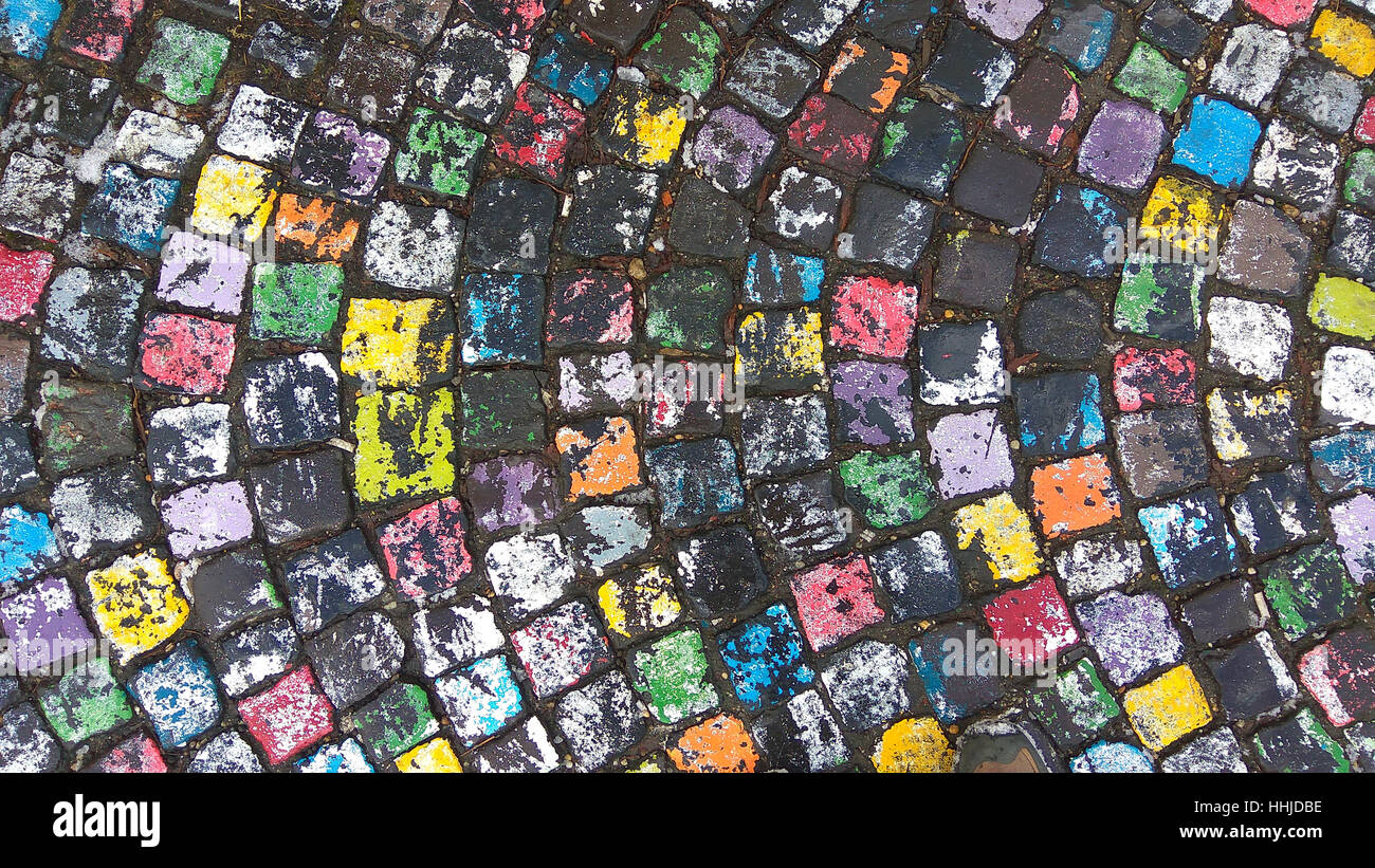 Many colored painted cobble stone pavement in after rain Stock Photo ...