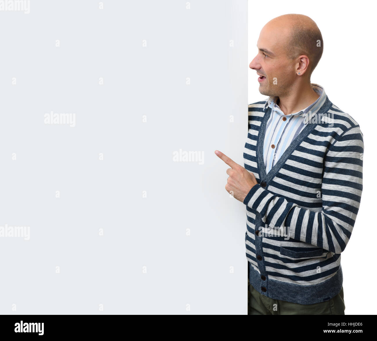 smiling bald Man pointing at blank poster Stock Photo - Alamy