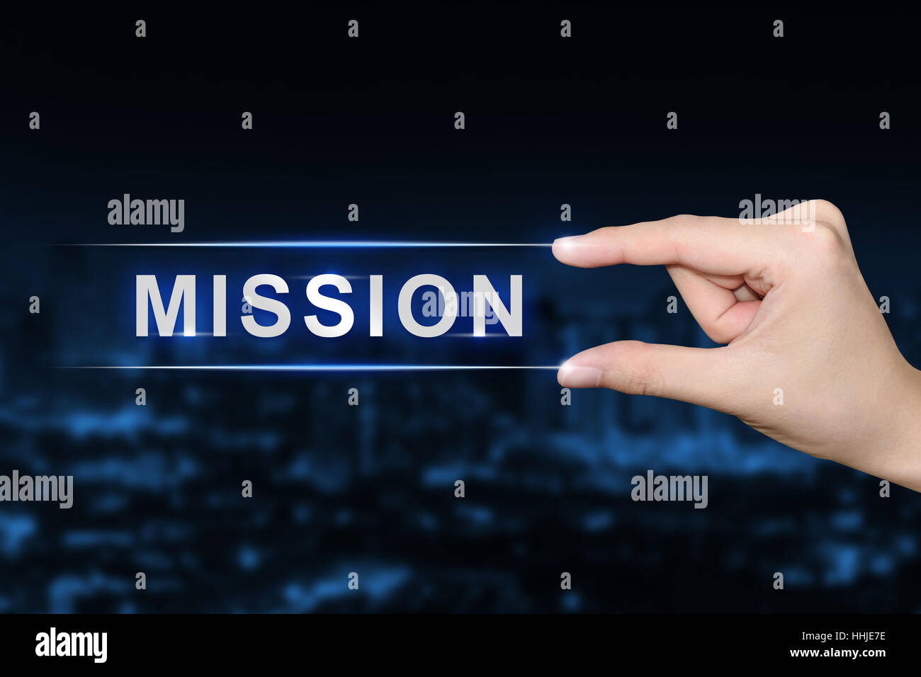 hand pushing mission button on blurred blue background Stock Photo - Alamy