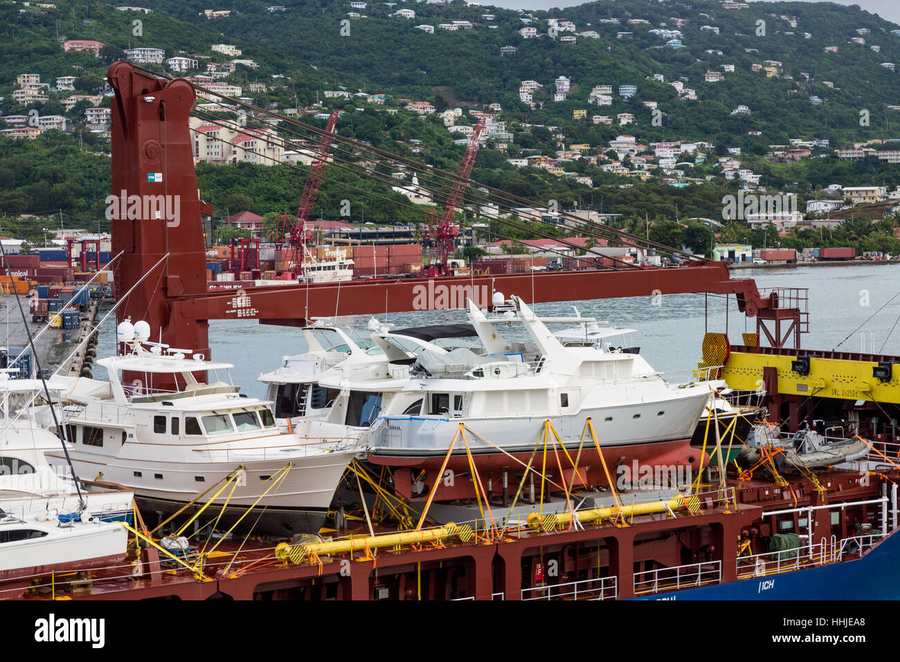 A ship delivering luxury yachts to a tropical harbor Stock Photo - Alamy
