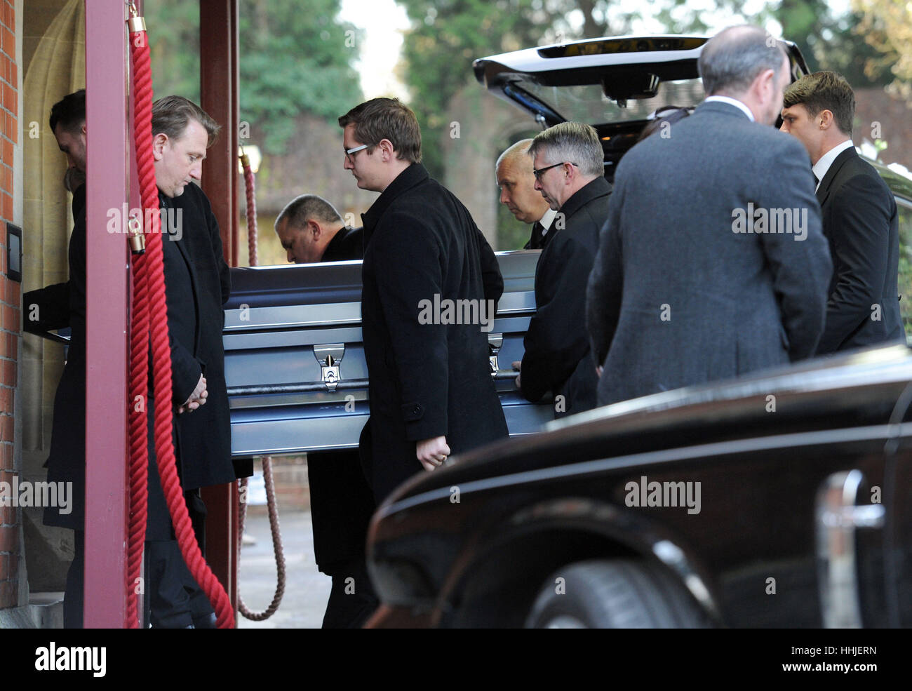 The coffin of Status Quo guitarist Rick Parfitt is carried into Woking ...