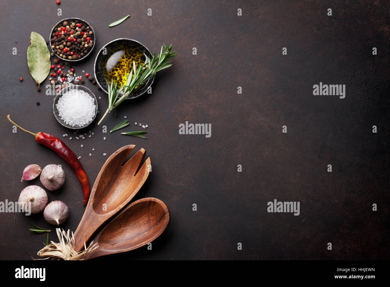 Cooking table with herbs, spices and utensils. Top view with copy space ...