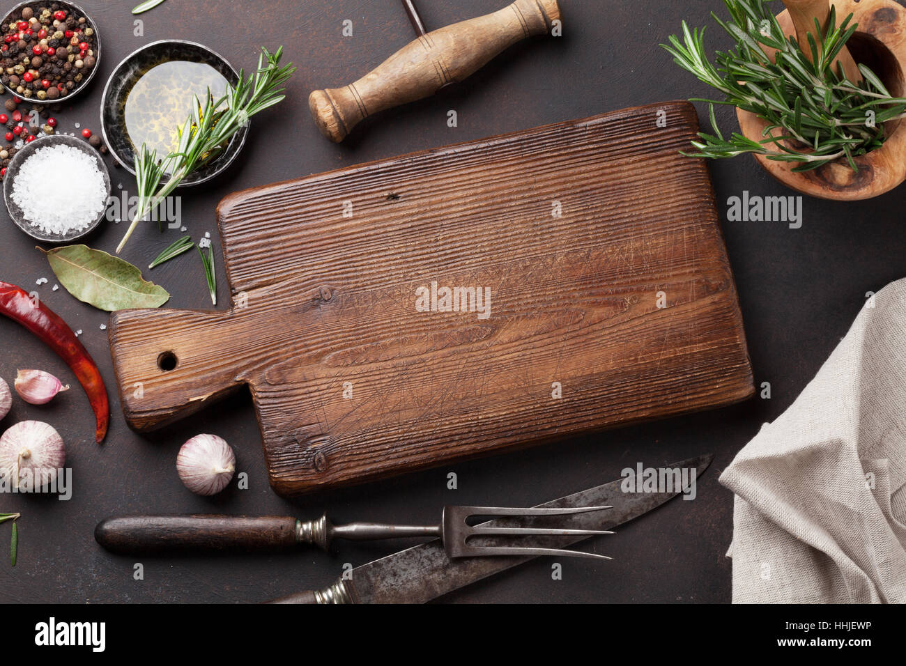 Cooking table with herbs, spices and utensils. Top view with copy space ...