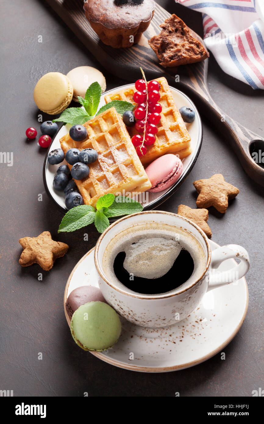 Coffee, sweets and waffles with berries Stock Photo - Alamy