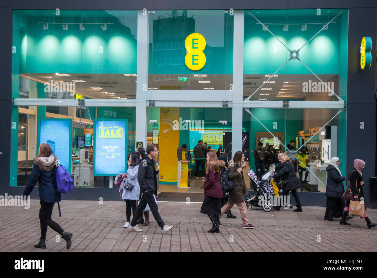 People passing EE Mobile Phone shop in a busy, crowded, Piccadilly ...