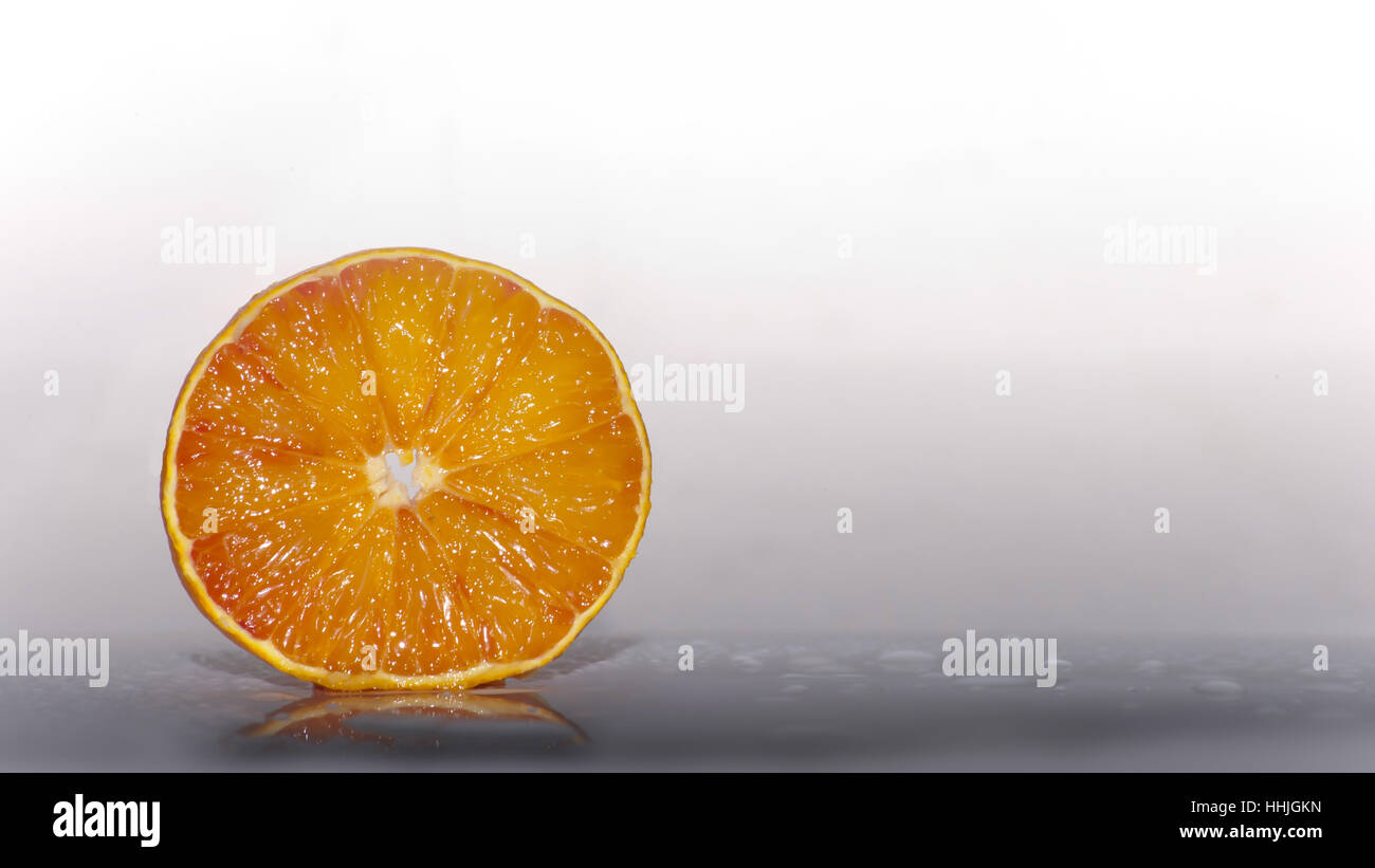 An fresh orange sliced in half Stock Photo - Alamy