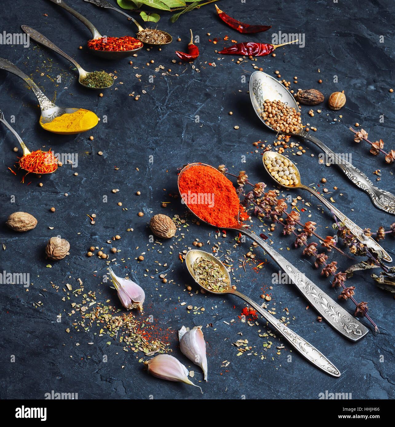 large set spicy spices in spoons on dark slate background Stock Photo ...