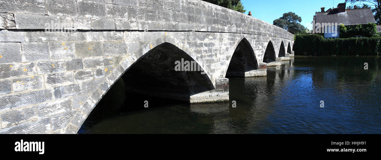 Summer view of the stone road bridge, Fordingbridge town; River Avon ...