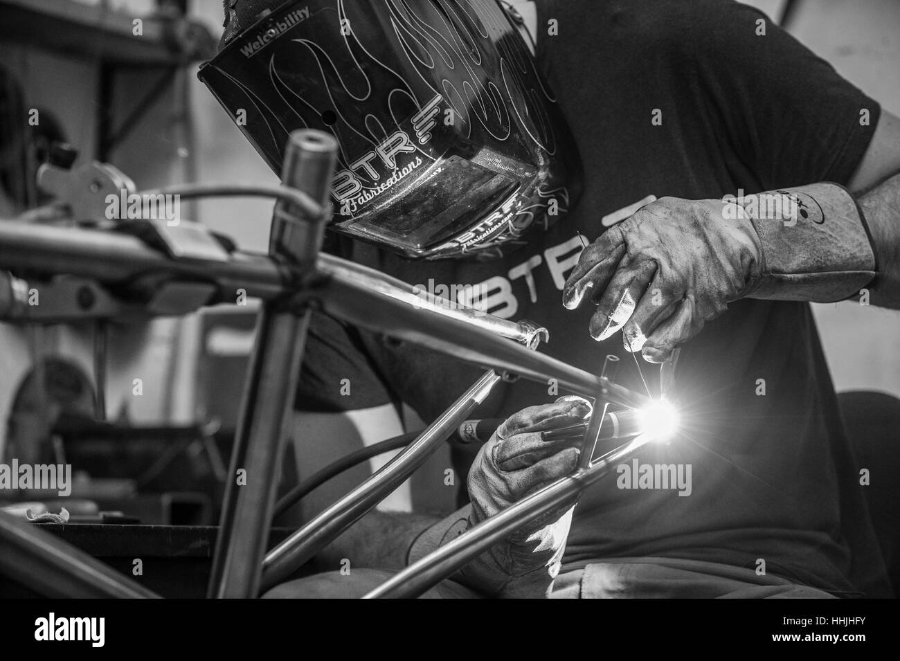 A bespoke steel mountain bike frame is TIG welded in a workshop Stock ...