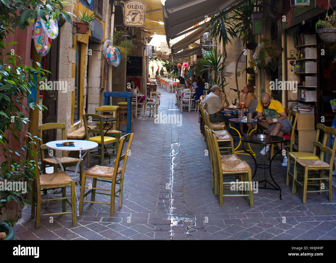 Pedestrian street in Chania, Greece, with bars and cafes with people ...