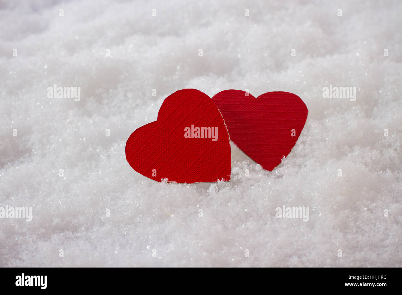 Two red hearts in the snow, top view Stock Photo - Alamy