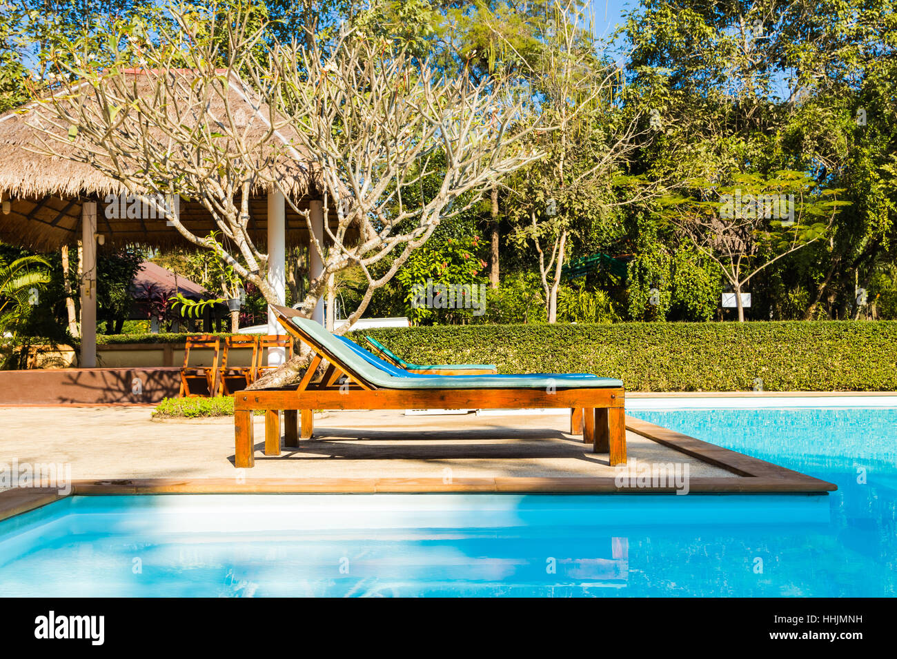 Beautiful luxury outdoor swimming pool with the lounge chair at ...
