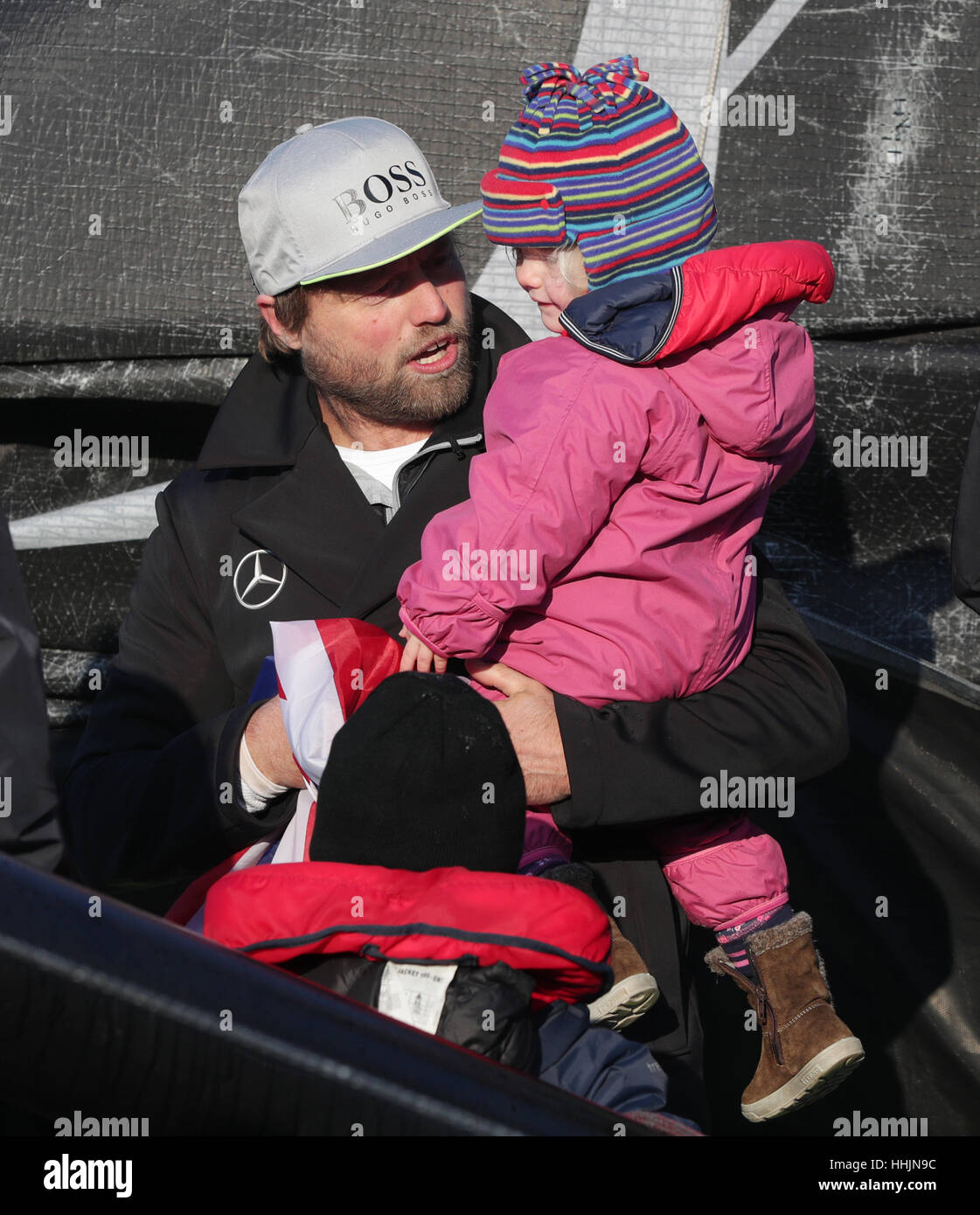 British sailor Alex Thomson holds his daughter Georgia on deck after ...
