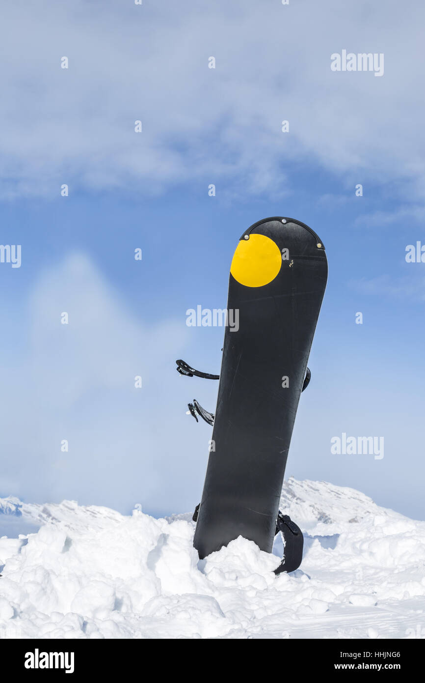 Image of a snowboard stuck in snow in mountains Stock Photo - Alamy