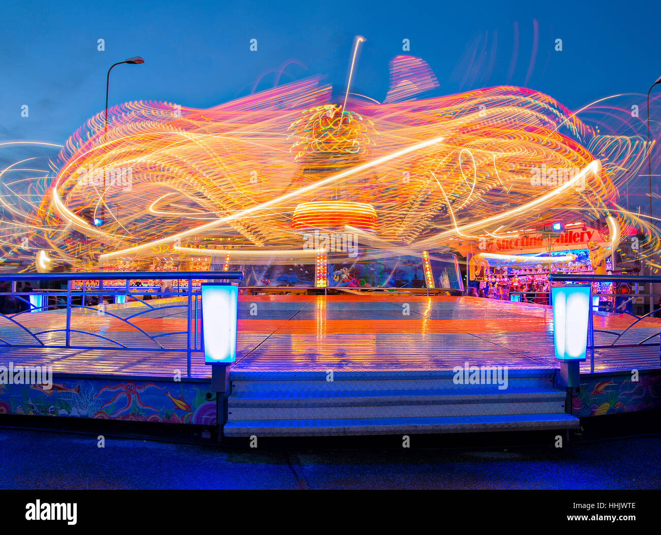 Revolving carousel is ride its visitors at speed Stock Photo - Alamy