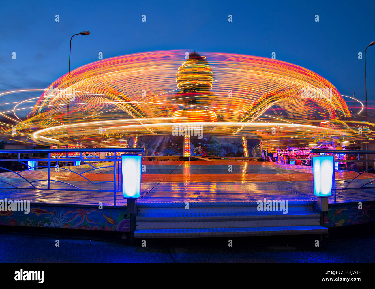 Revolving carousel enlarge its ride speed by twice Stock Photo - Alamy