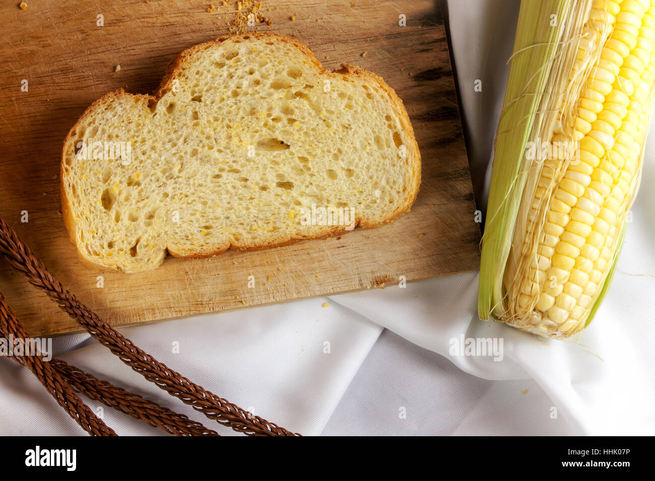 bread made from corn on the white fabric. Slices of corn bread laying ...