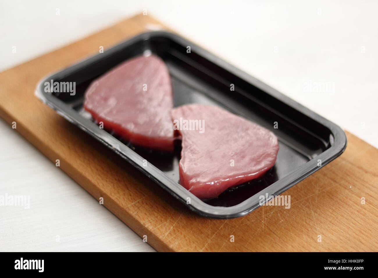Raw tuna steak in disposable plastic packing box Stock Photo - Alamy