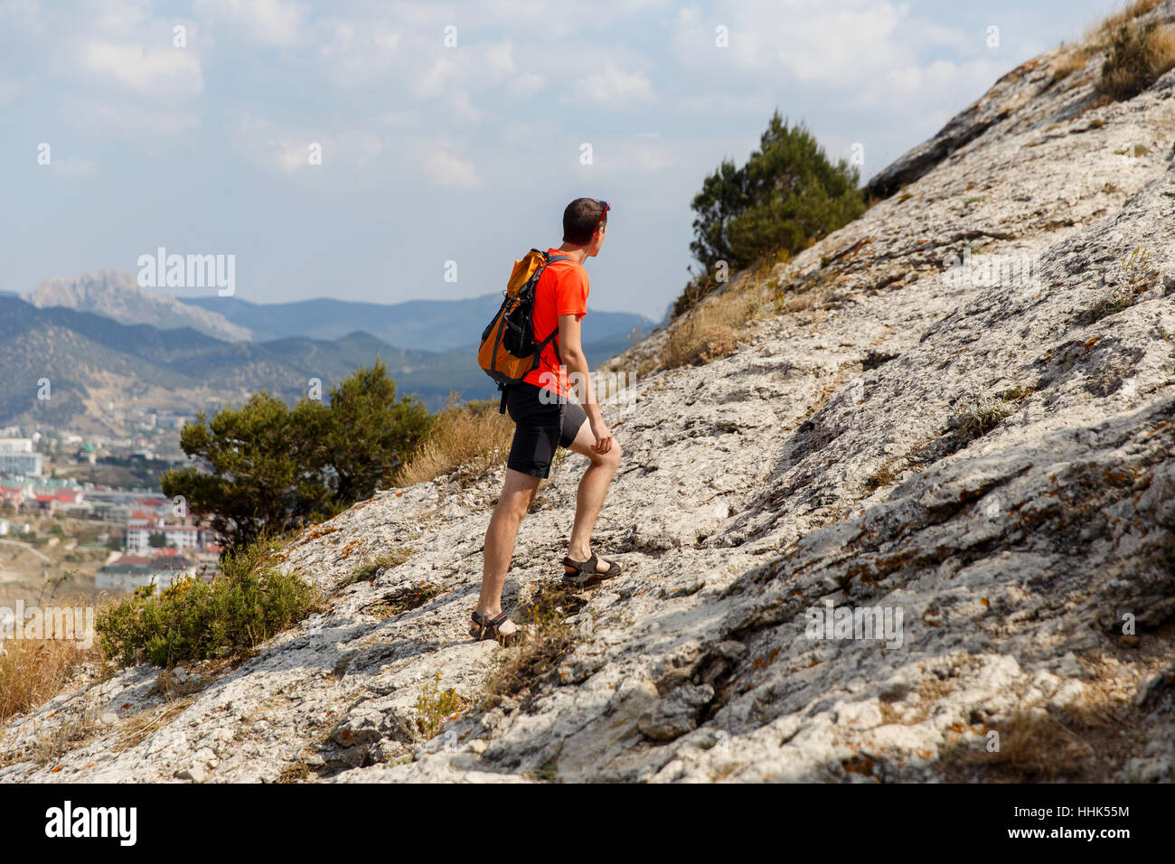 Man going up on mountain Stock Photo - Alamy
