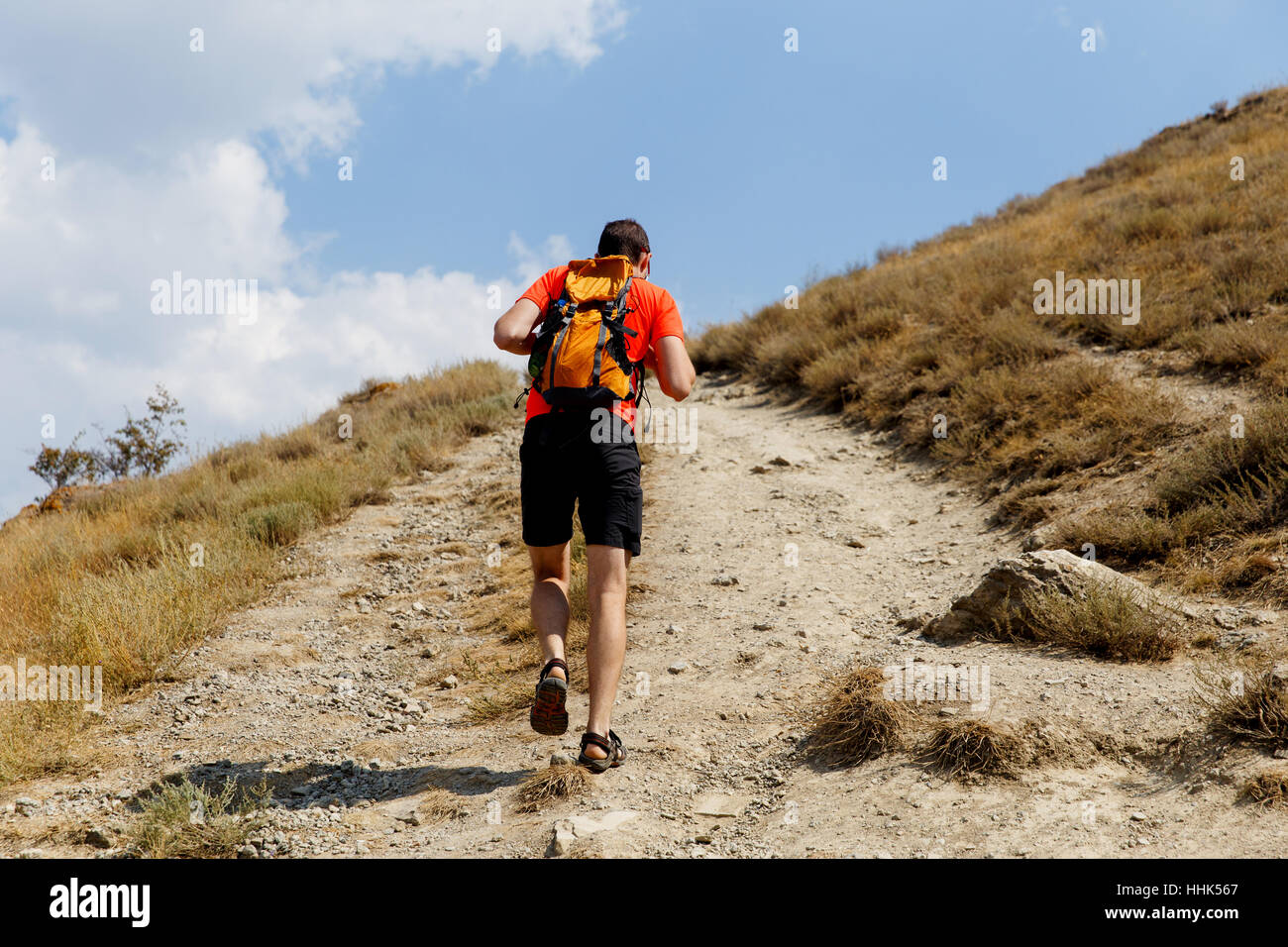 Man hiking up steep hill hi-res stock photography and images - Alamy