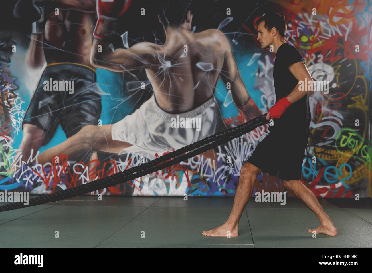 Training young athlete with rope Stock Photo - Alamy