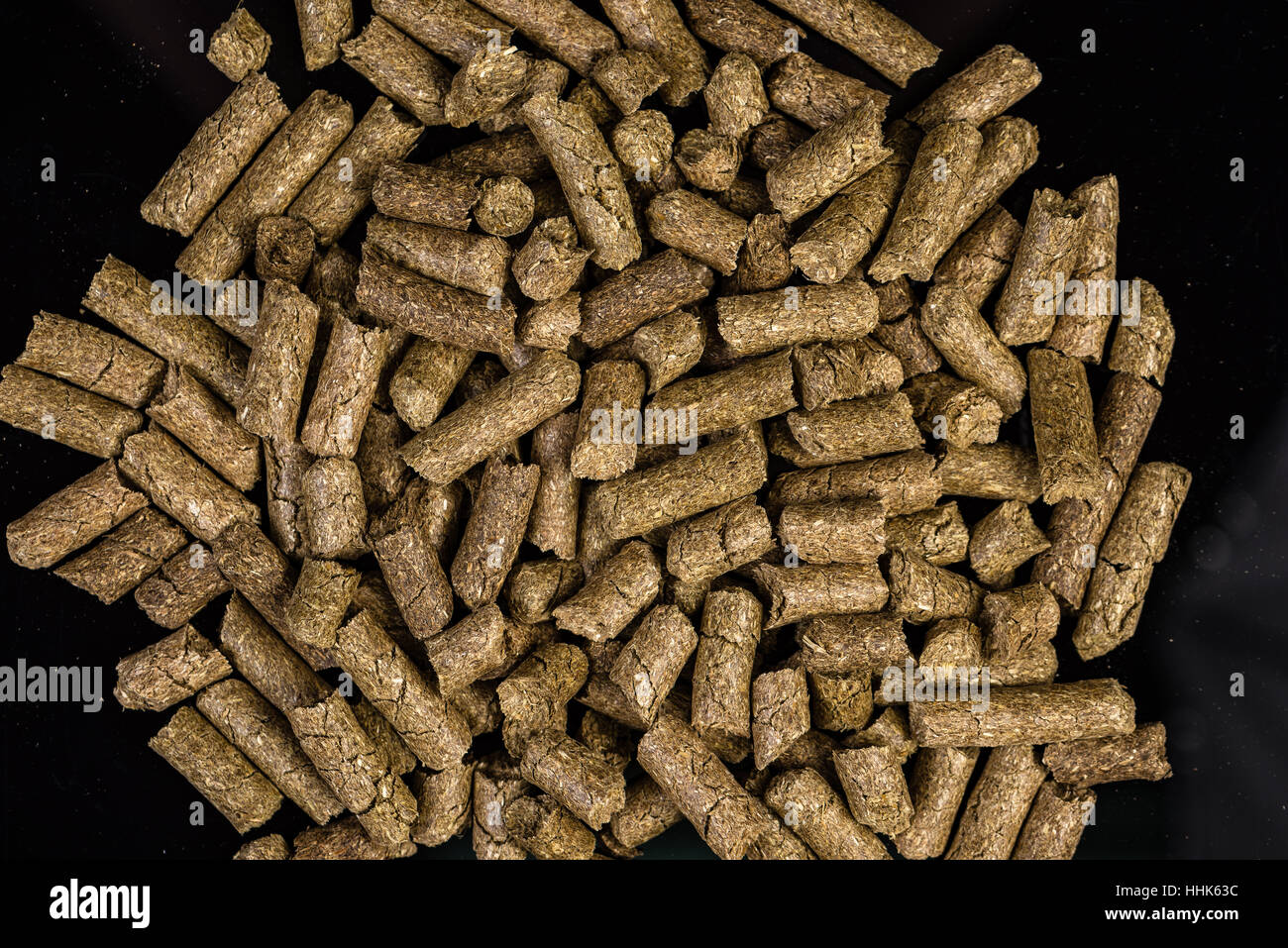 granulated animal food background texture isolated on black Stock Photo ...