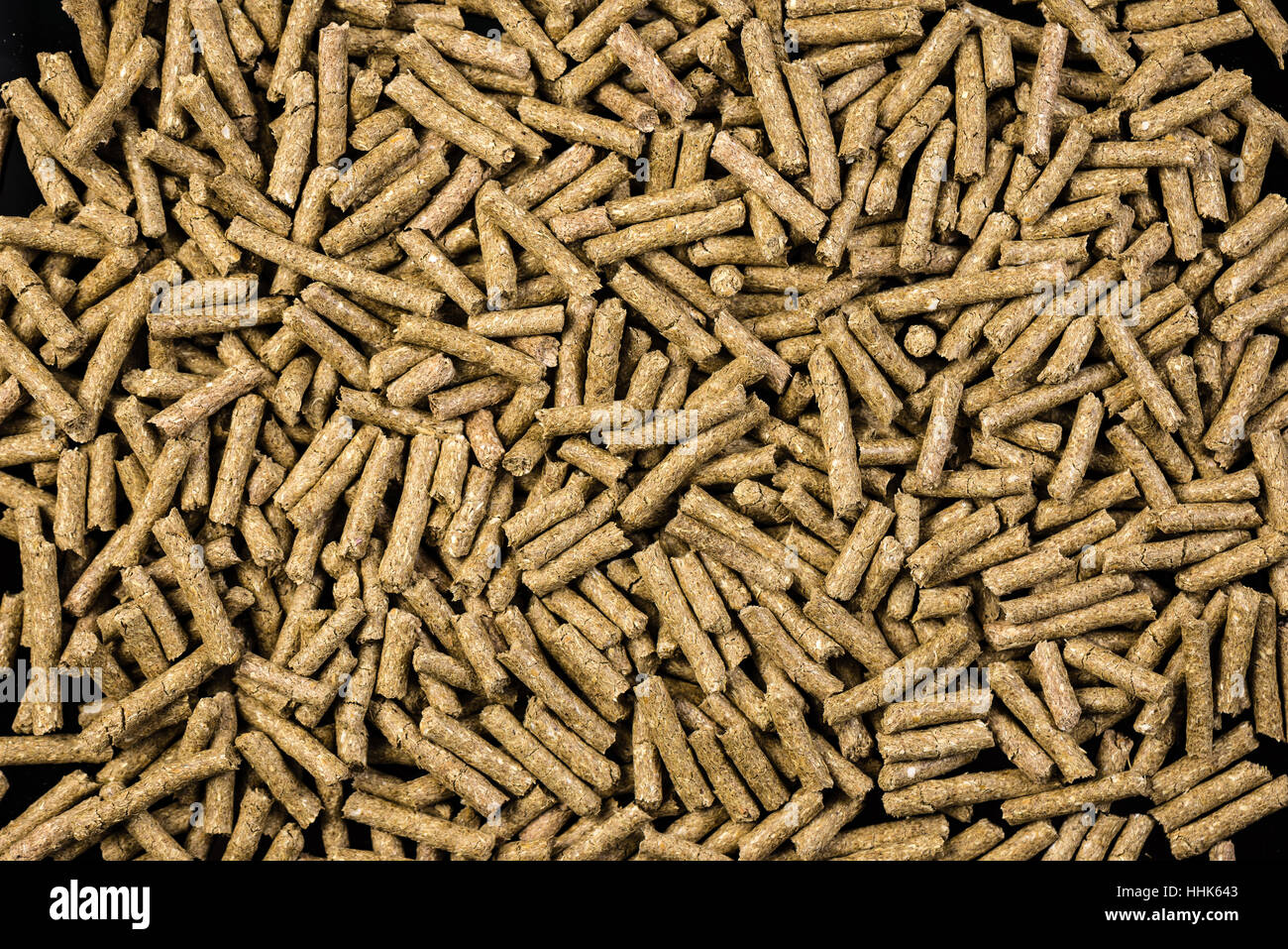 granulated animal food background texture isolated on black Stock Photo ...