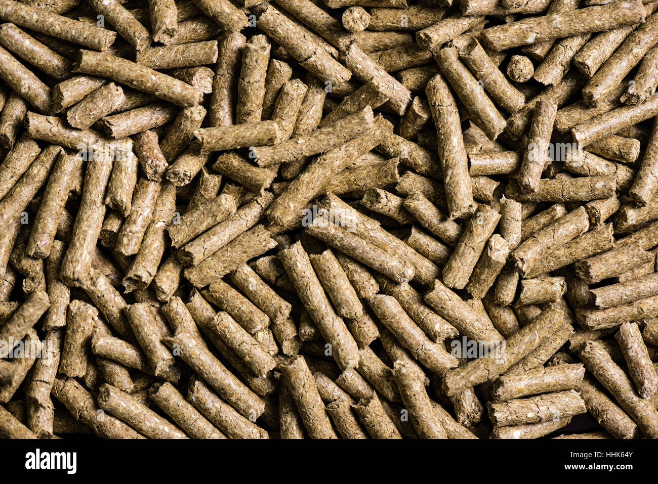 granulated animal food background texture isolated on black Stock Photo ...