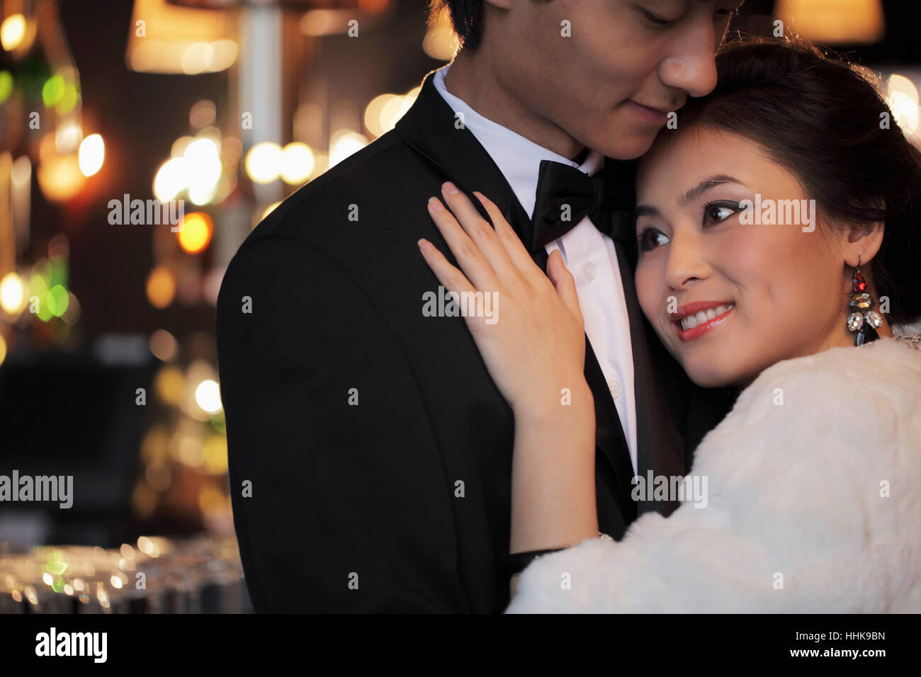 Dressed up couple hugging each other at night Stock Photo - Alamy