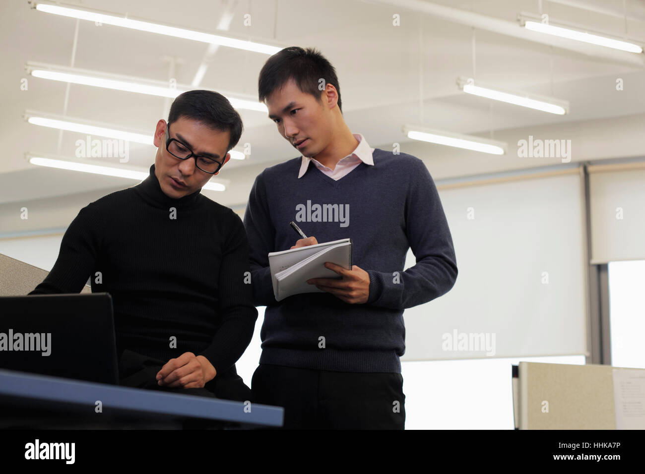 Two men working together in an office Stock Photo - Alamy