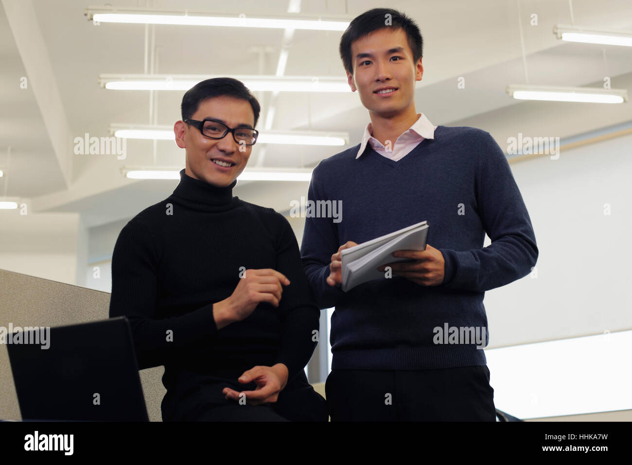 Two men working together in an office Stock Photo - Alamy