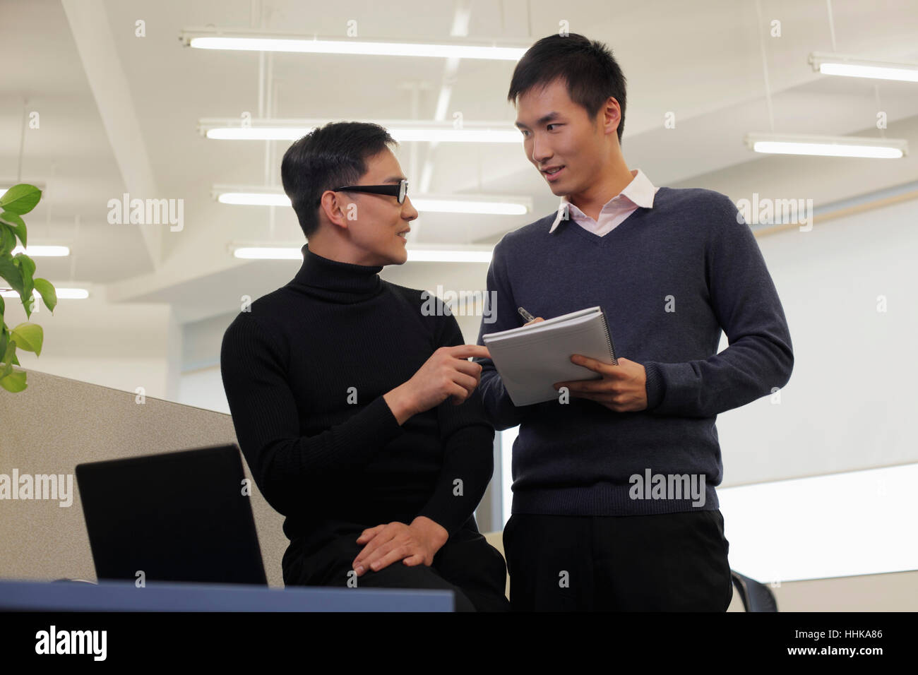 Two men working together in an office Stock Photo - Alamy