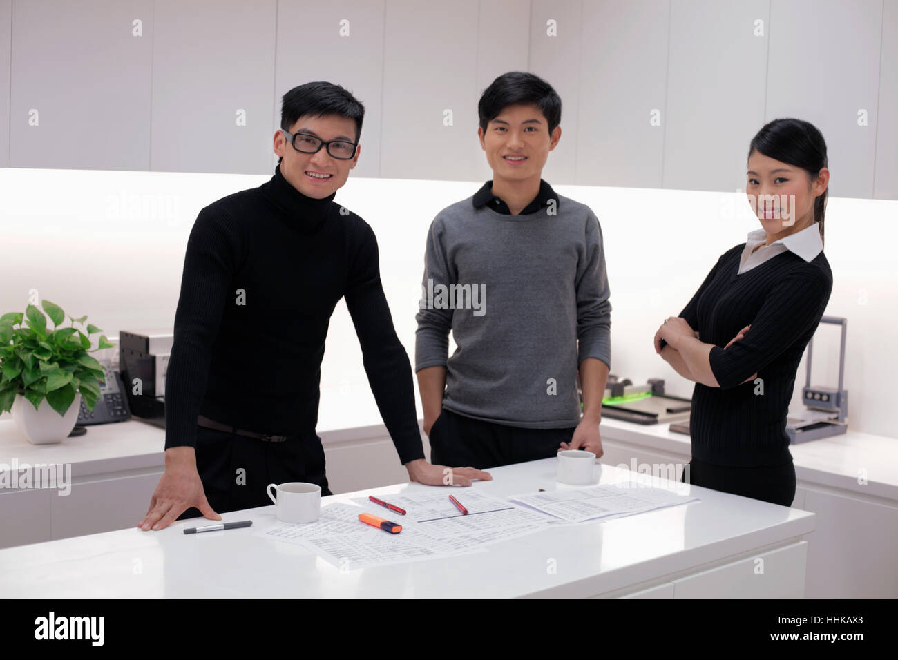 Three people working together in modern office building Stock Photo - Alamy