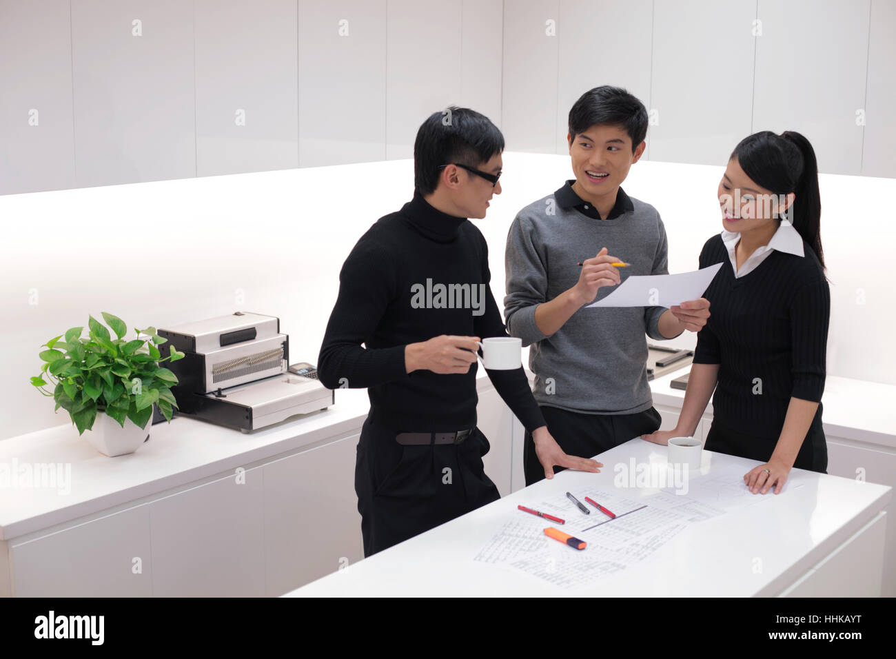 Three people working together in modern office Stock Photo - Alamy