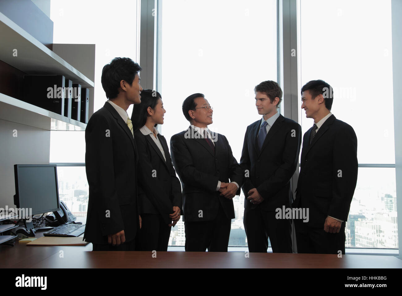 Small group of business people talking together Stock Photo - Alamy